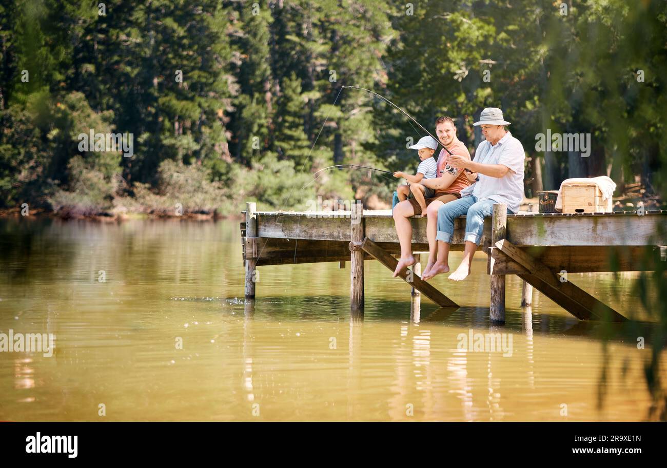 Father, grandfather and child fishing at lake together for fun bonding ...