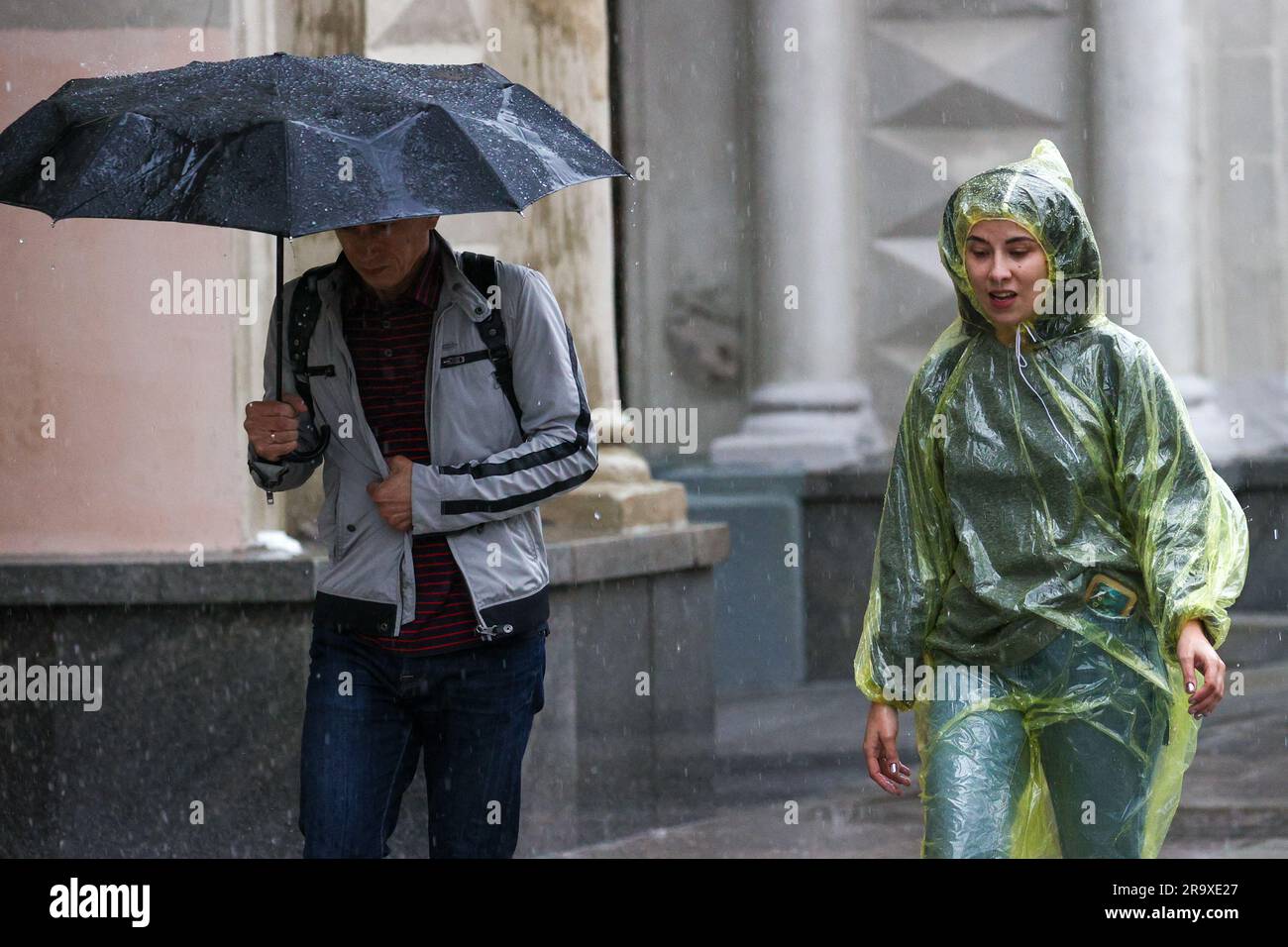 People under umbrellas during the rain in Moscow Stock Photo - Alamy