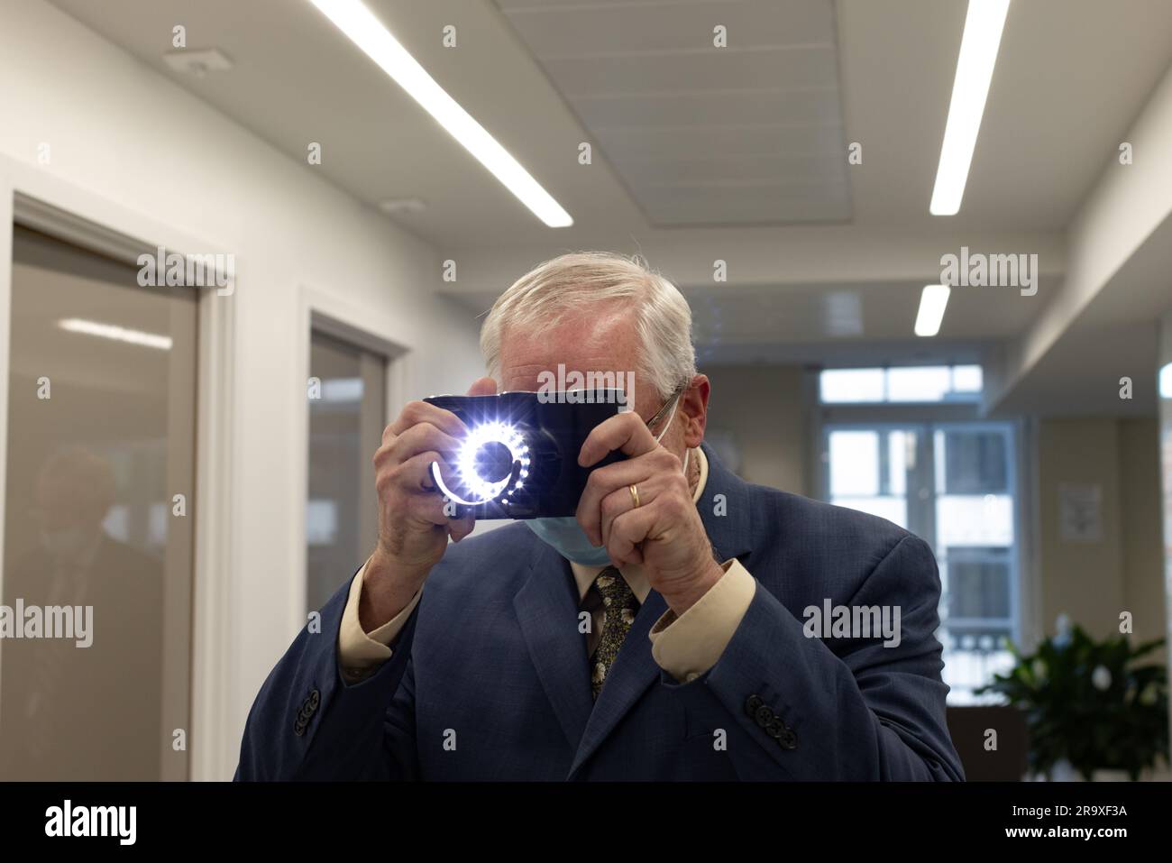 Doctor using a 'Dermlite' device, enabling him to detect skin ...