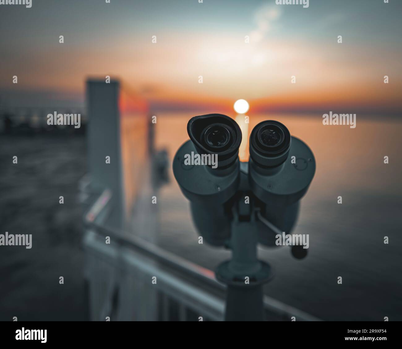 A Close up of binoculars on a sunset sky background Stock Photo - Alamy