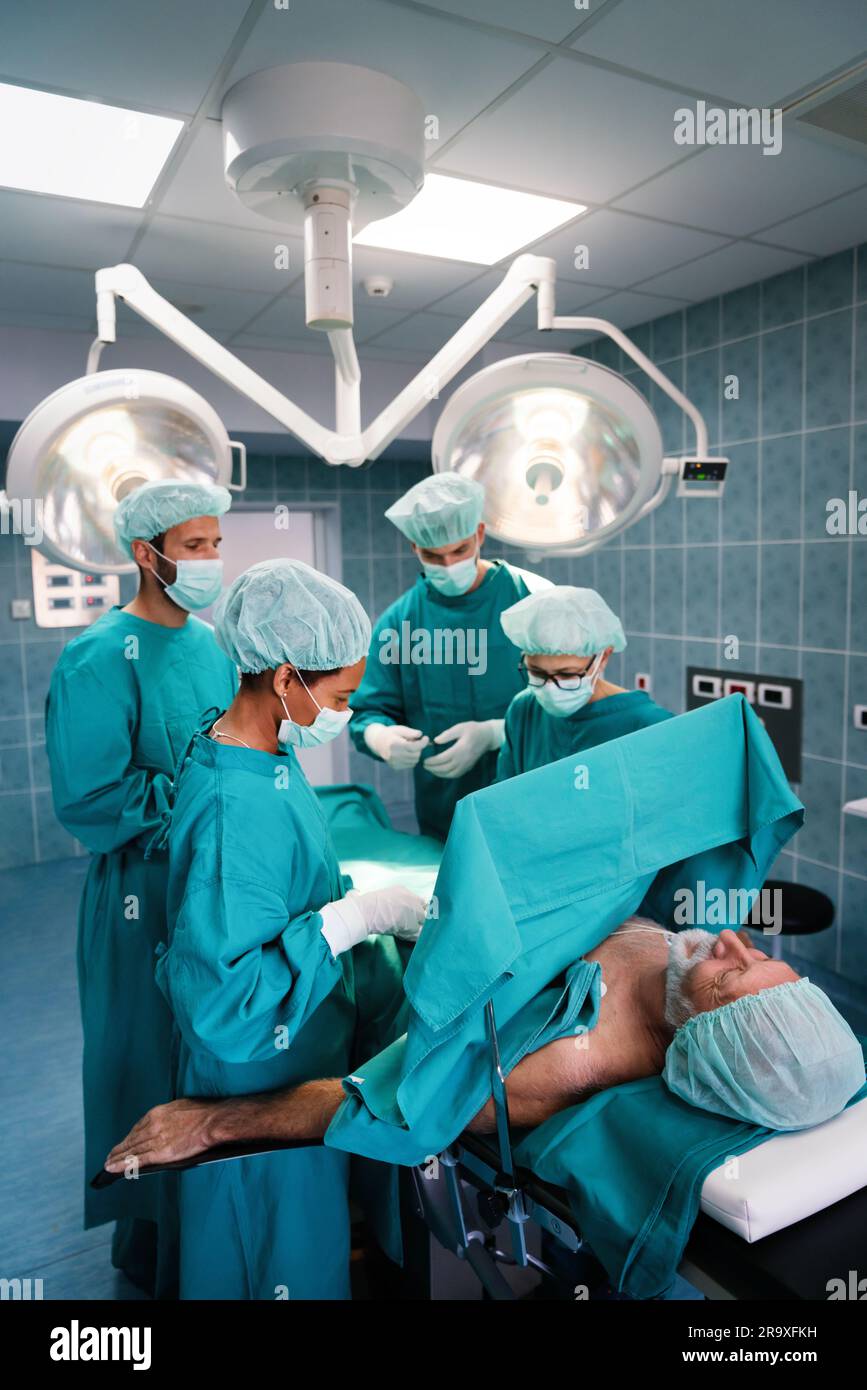 Group of surgeon doctor team at work in operating room Stock Photo - Alamy