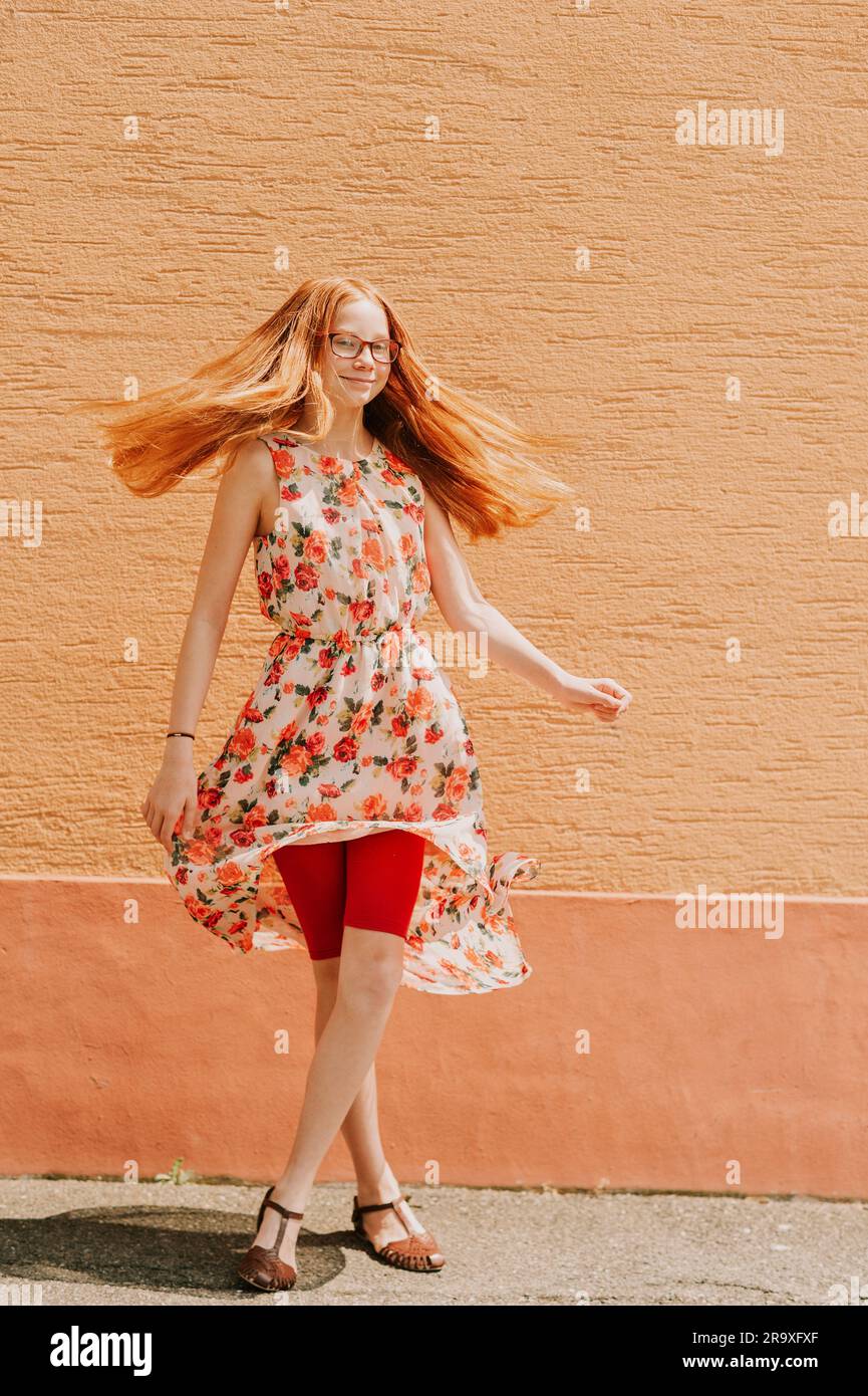 Portrait of adorable preteen kid girl of 10-11 yers old with long red ...