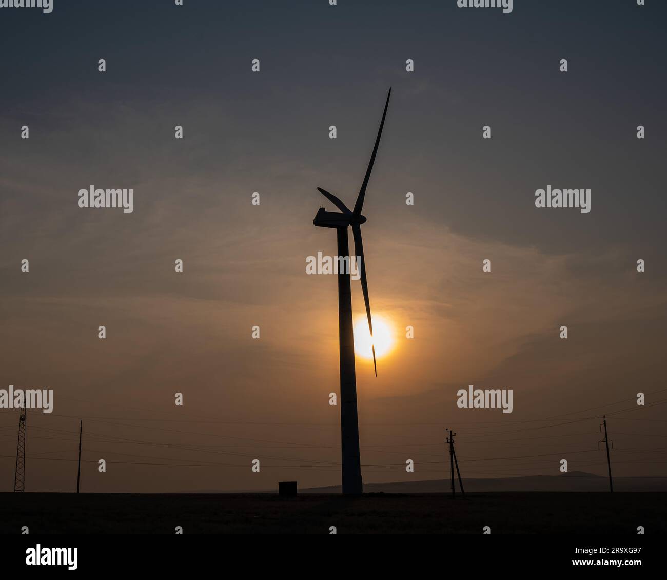 Windmill at sunset. Alternative energy source Stock Photo - Alamy