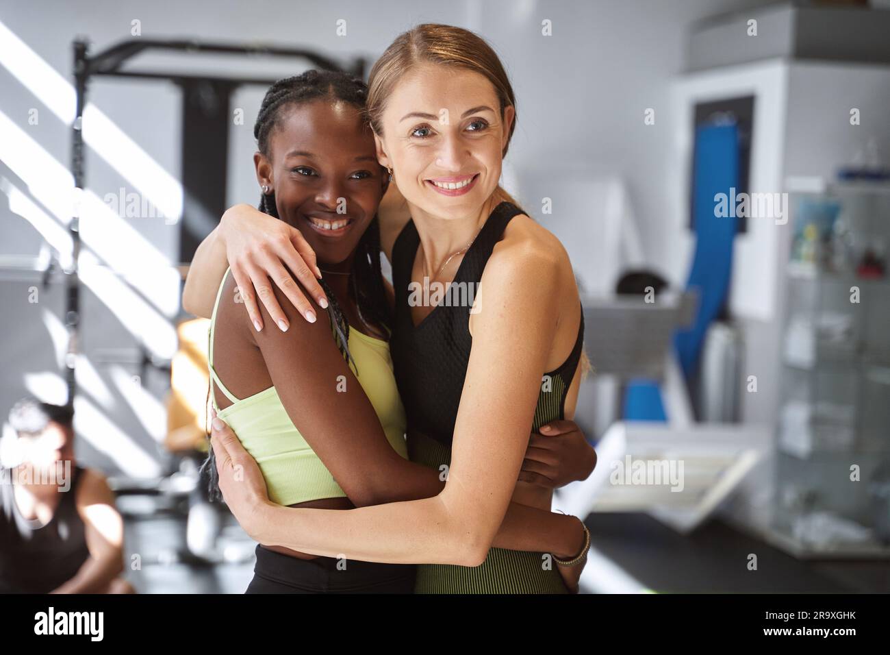 Two fit women hugging hi-res stock photography and images - Alamy