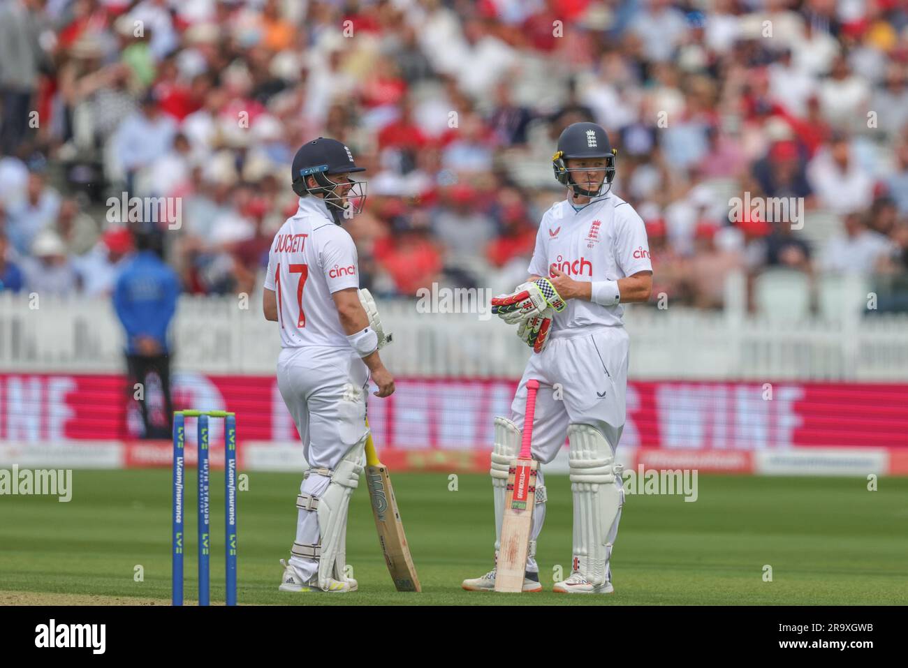 Ollie Pope of England and Ben Duckett of England chat while the umpires ...