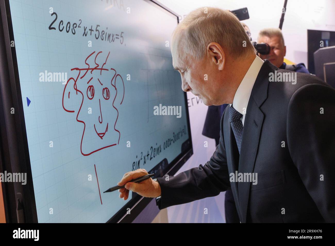 Russian President Vladimir Putin draws on a multimedia blackboard as he ...