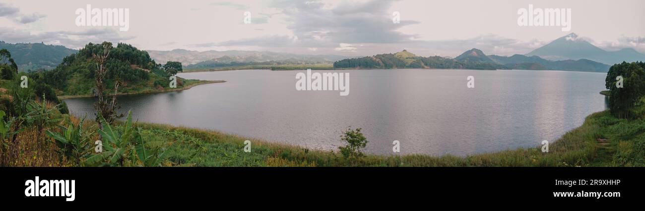 A panoramic view of Lake Mutanda against the background of Mount ...