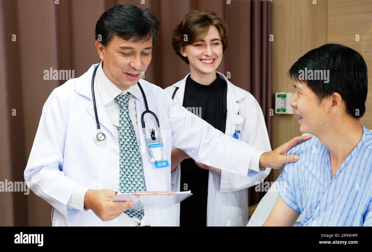 Doctors visiting and talking with patient during medical examination ...