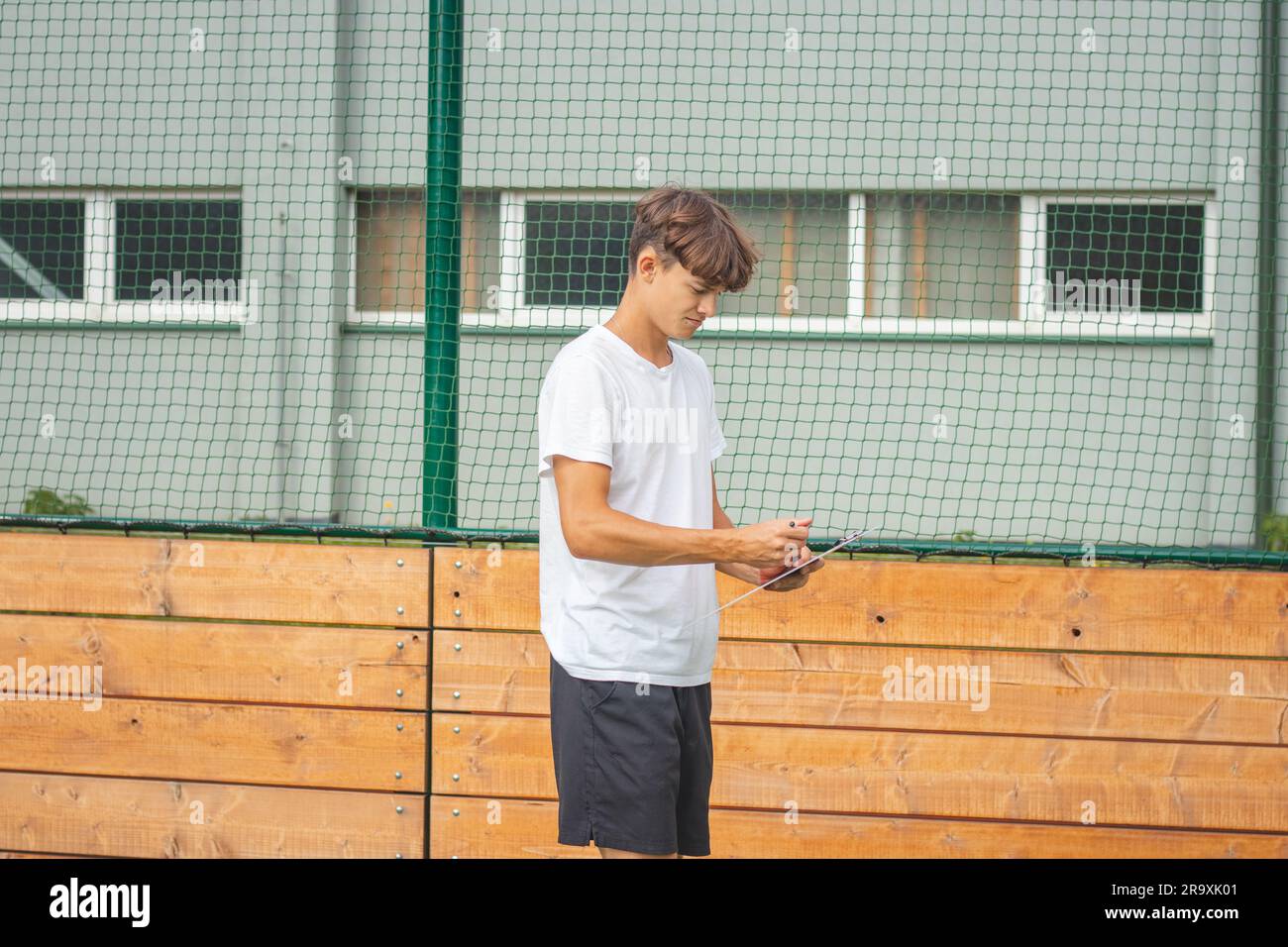 Young, ambitious coach instructs his players on what to do on the field ...