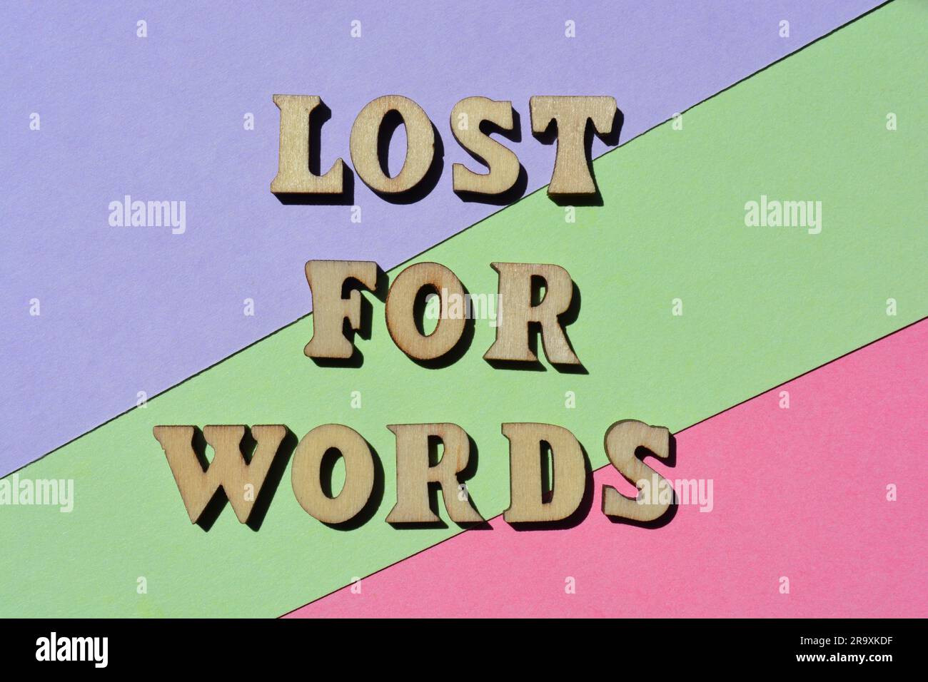 Lost For Words, phrase in wooden alphabet letters isolated on colourful ...