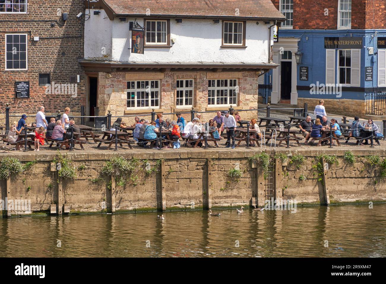 People dining outside a river side restaurant in York, UK Stock Photo ...