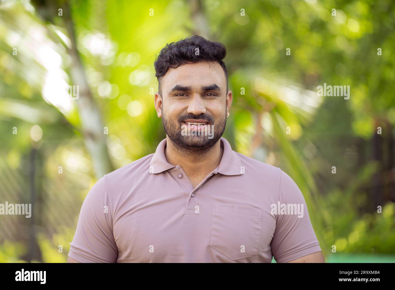 portrait shot of Happy smiling indian man standing by looking camera at ...