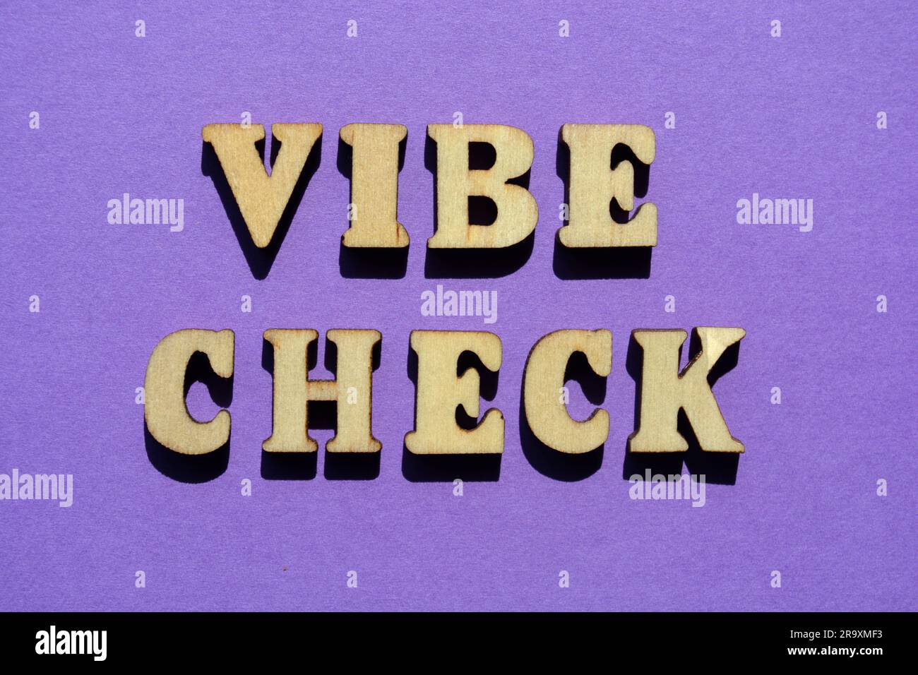 Vibe Check, words in wooden alphabet letters isolated on purple ...