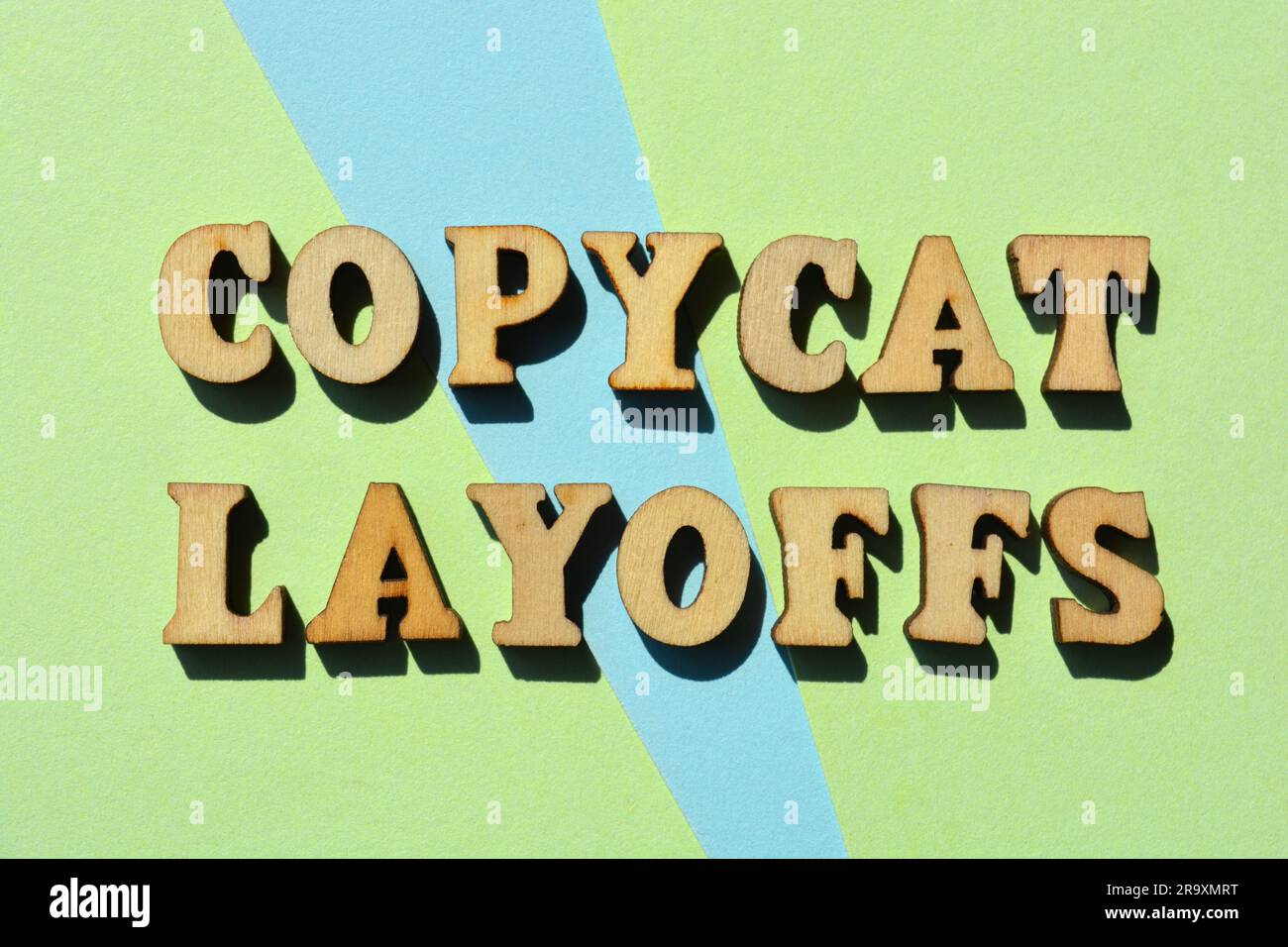 Copycat Layoffs, words in wooden alphabet letters isolated on ...