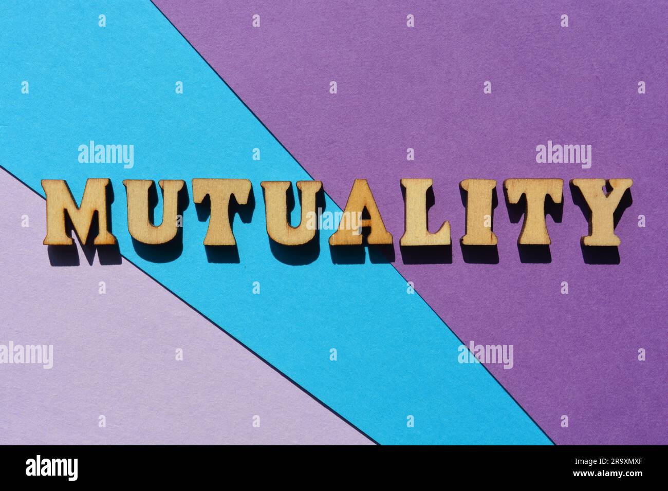 Mutuality, word in wooden alphabet letters isolated on background ...