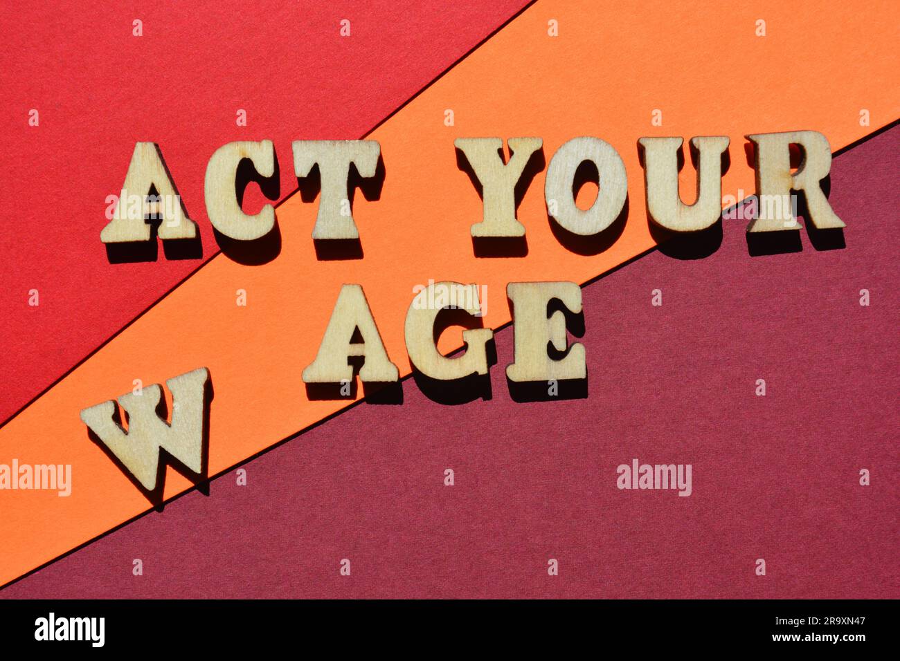 Act Your Age, Act Your Wage, words in wooden alphabet letters isolated ... Act Your Age, Act Your Wage, words in wooden alphabet letters isolated ...