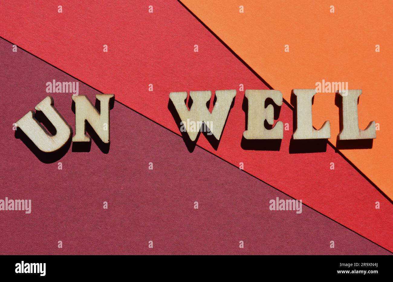 Well, Unwell, words in wooden alphabet letters isolated on background ...
