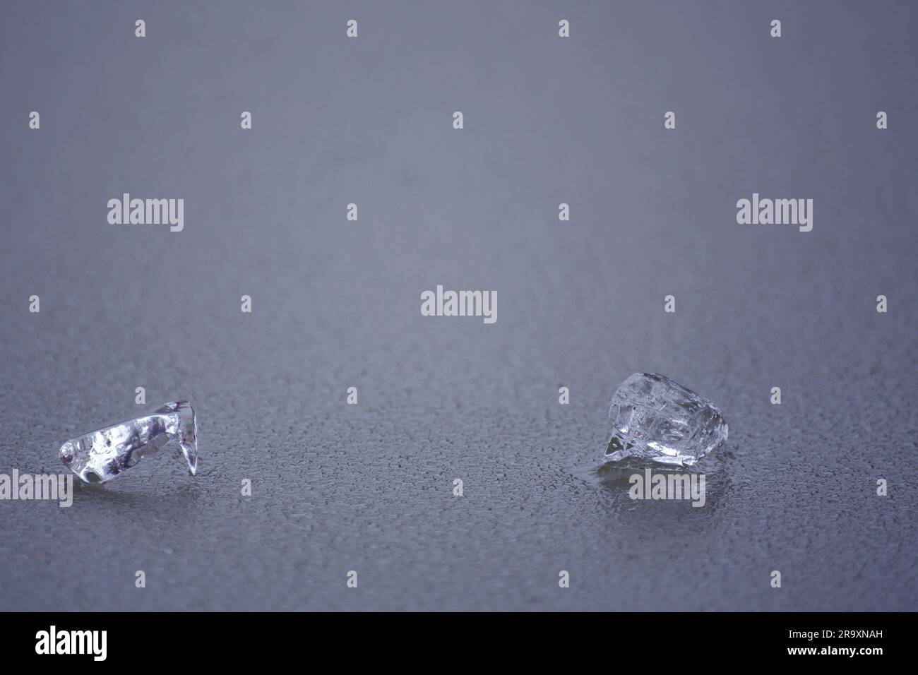 Two transparent chunks of ice on a frozen surface of water Stock Photo ...