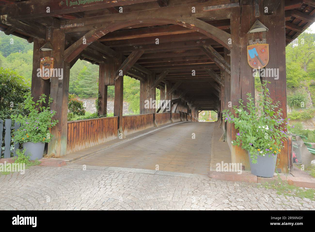 Covered historic wooden bridge with city arms and landmarks of Forbach ...