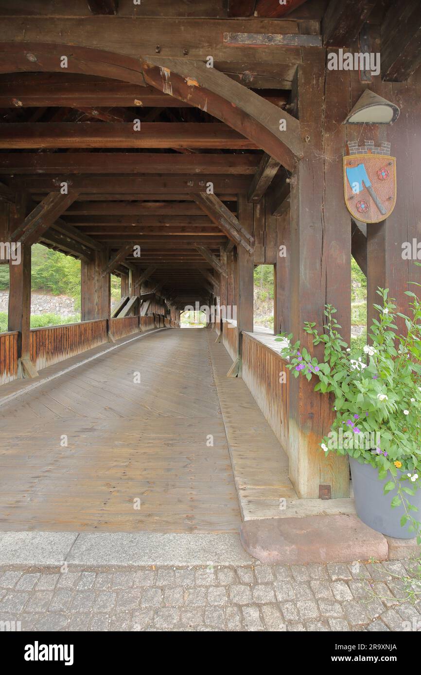 Covered historic wooden bridge with city arms and landmarks in Forbach ...