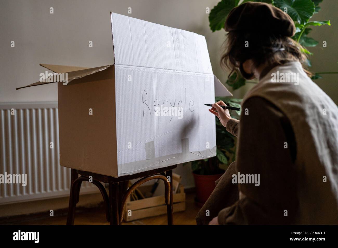Ecological activist girl signs cardboard box for things be recycled ...