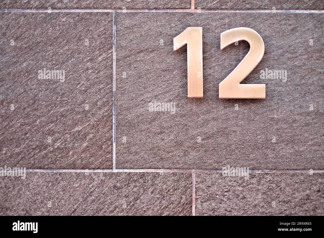 Elegant number 12 / twelve, metal digits on masonry background Stock ...