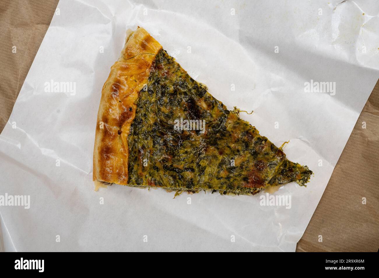 A slice of traditional spinach Pie Genoa Style on white paper Stock ...