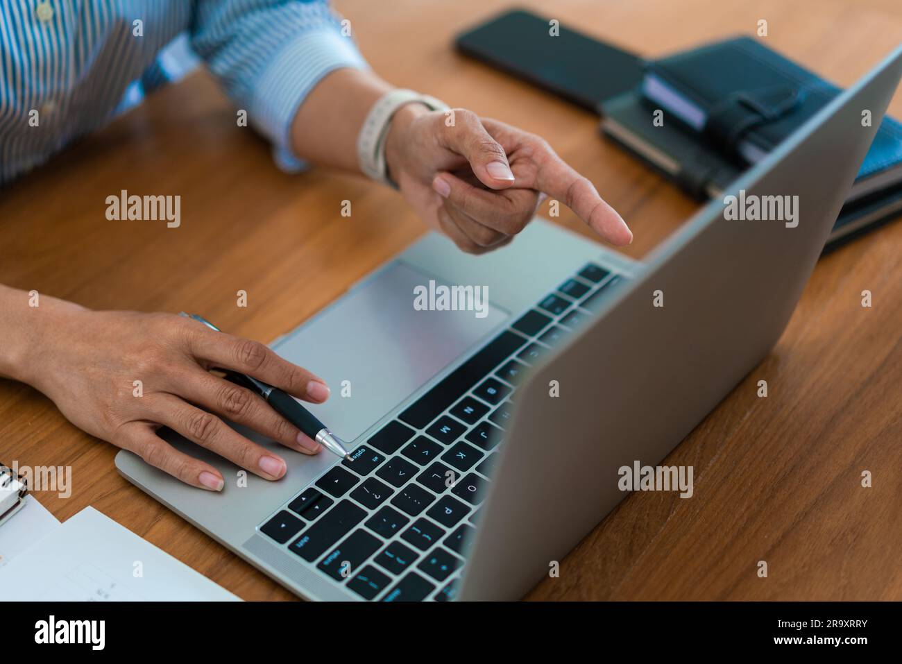 Close up hands of businesswoman is pointing on screen to reading data ...