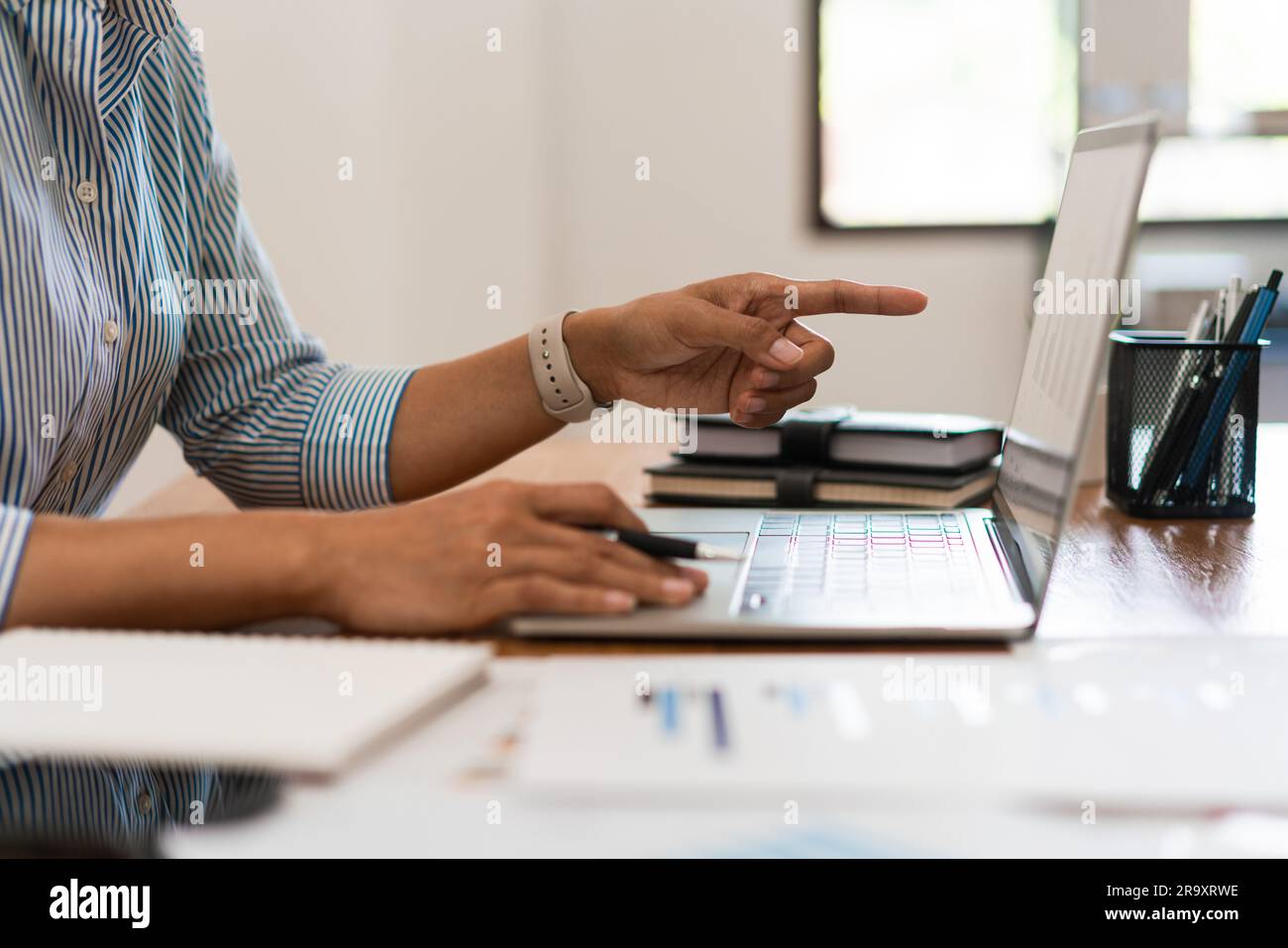 Close up hands of businesswoman is pointing on screen to reading data ...