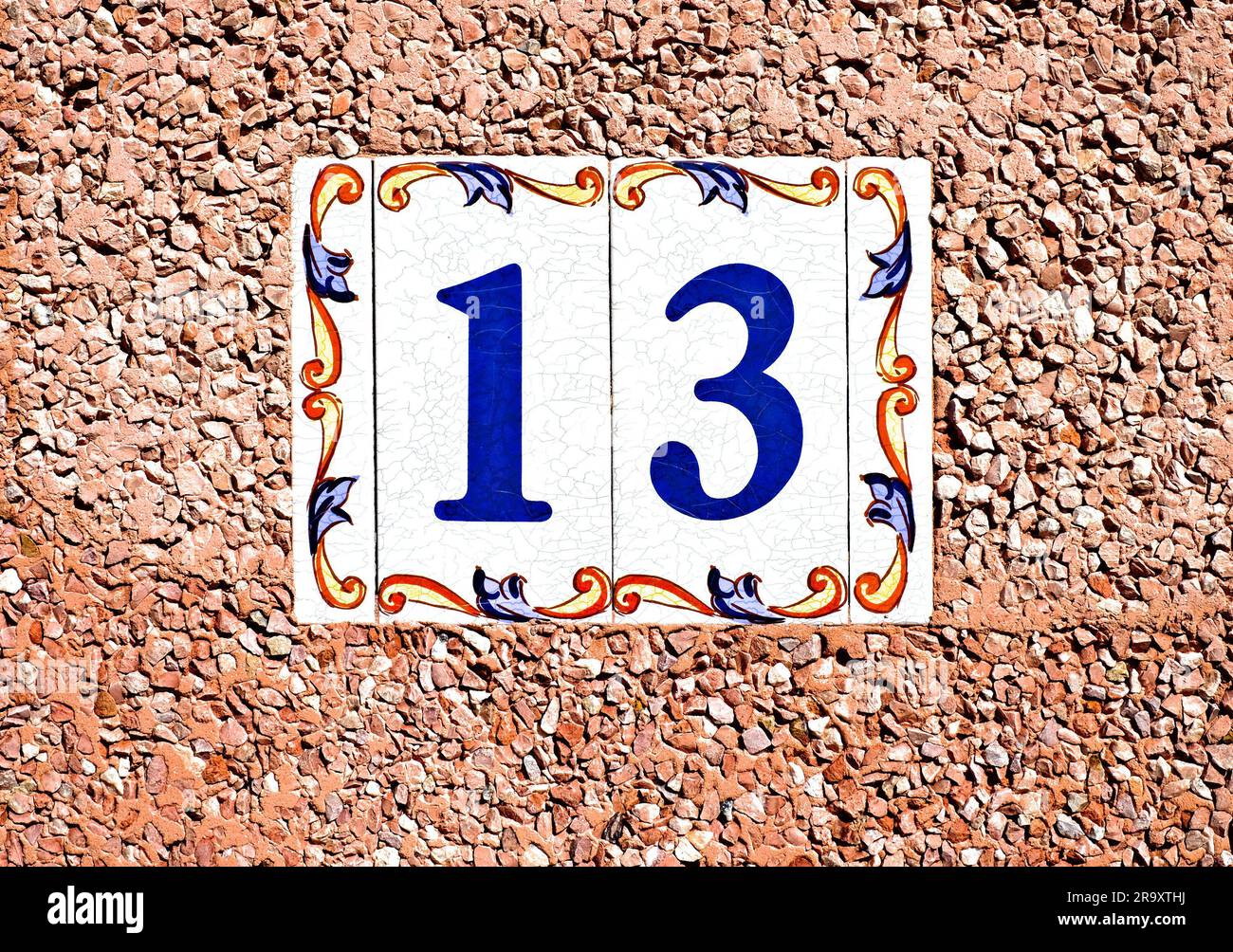 Unlucky lucky number thirteen / 13 in decorative tiles on a pink ...