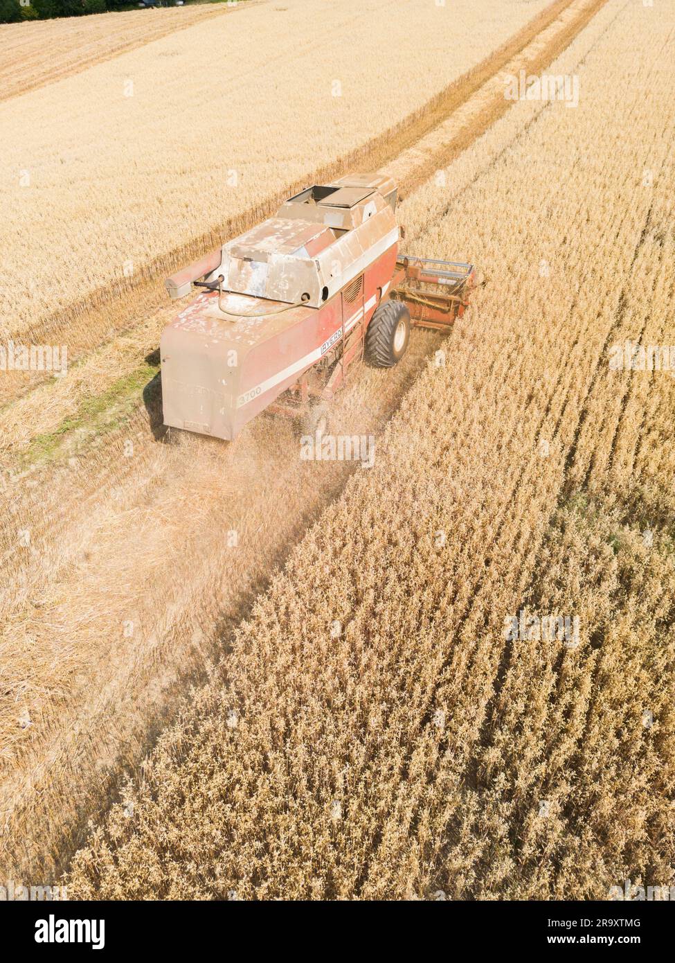 Aerial photographs of a combine harvester and tractors harvesting ...
