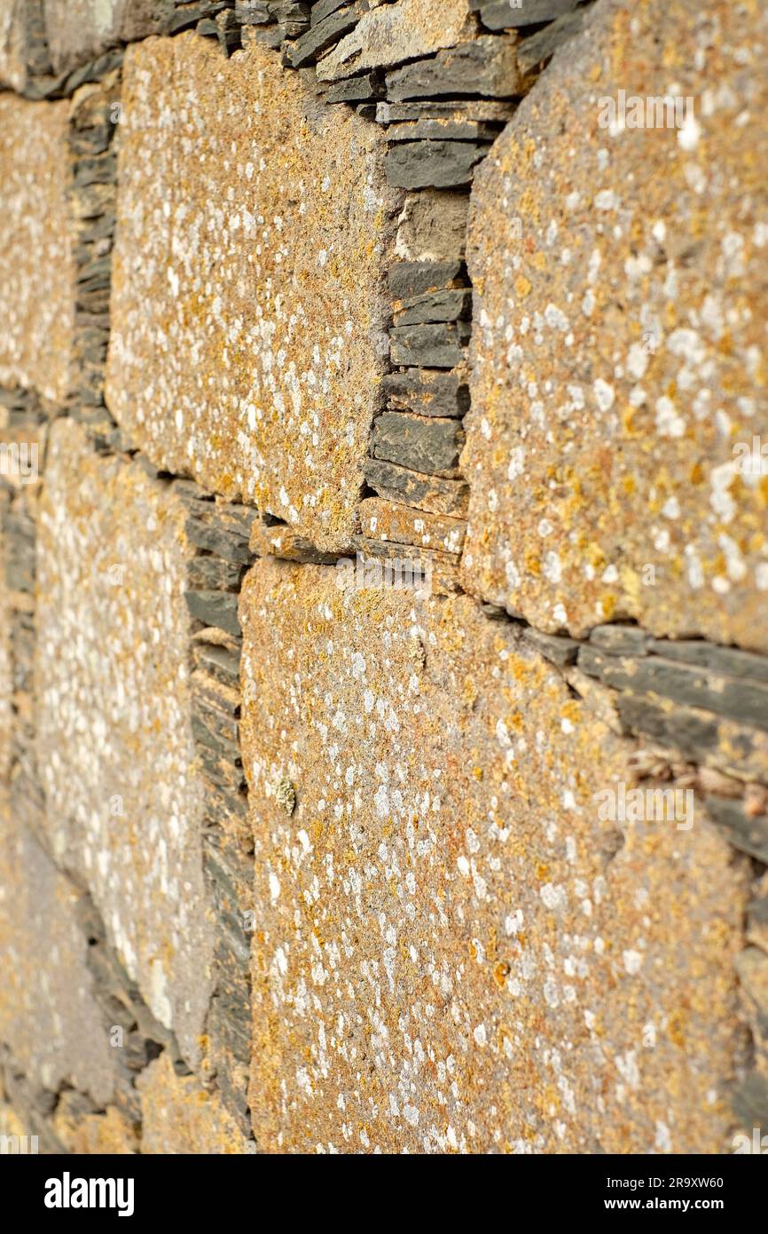 Old hand laid sandstone wall, perspective view Stock Photo - Alamy