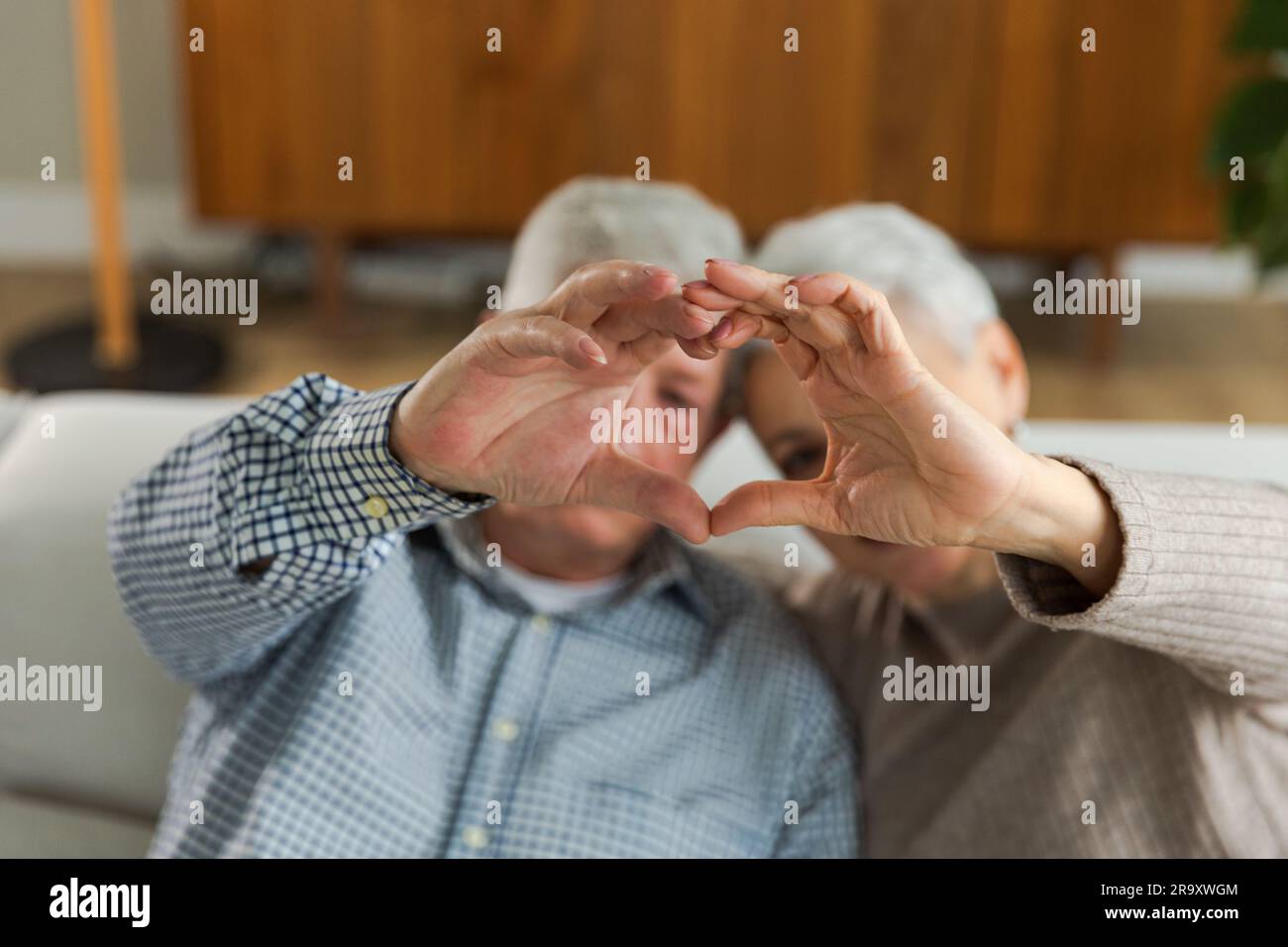 Elderly woman showing symbol love hi-res stock photography and images ...