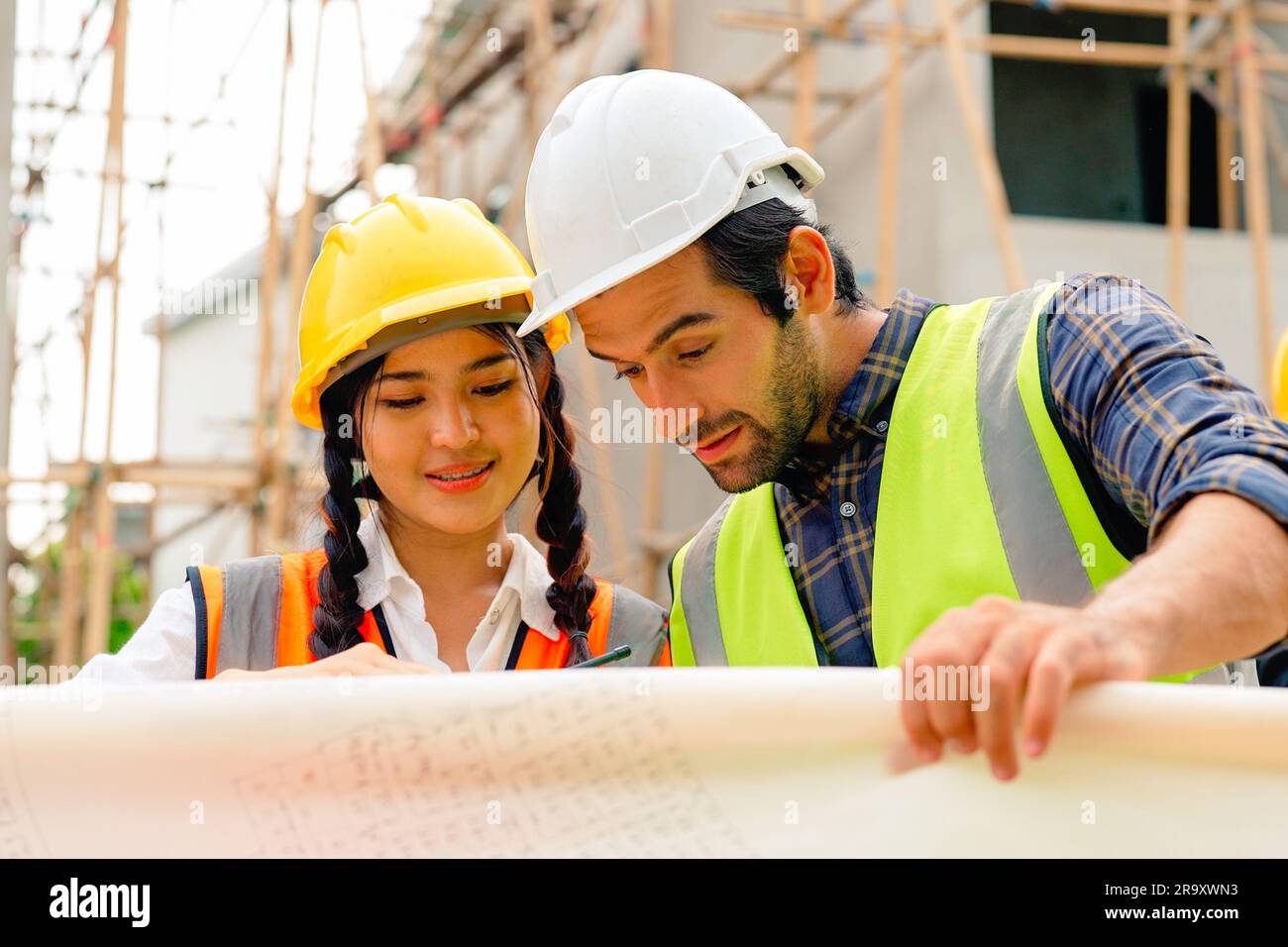 Civil engineers team with safety hard hat working together at ...