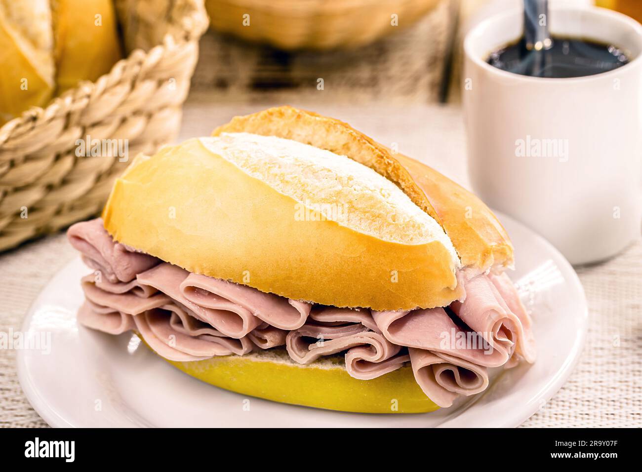 typical brazilian snack, pão de sal with slices of mozzarella cheese ...