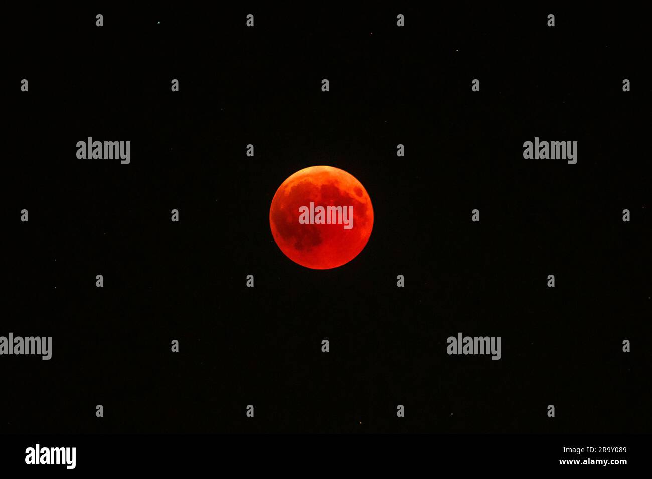 Details of full red moon over dark black sky by night. The total phase ...