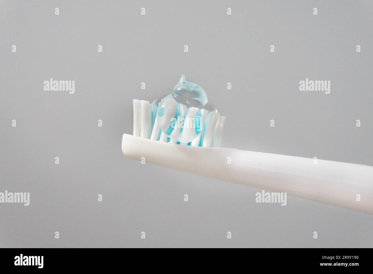 white toothbrush with cristal transparent toothpaste on. white ...