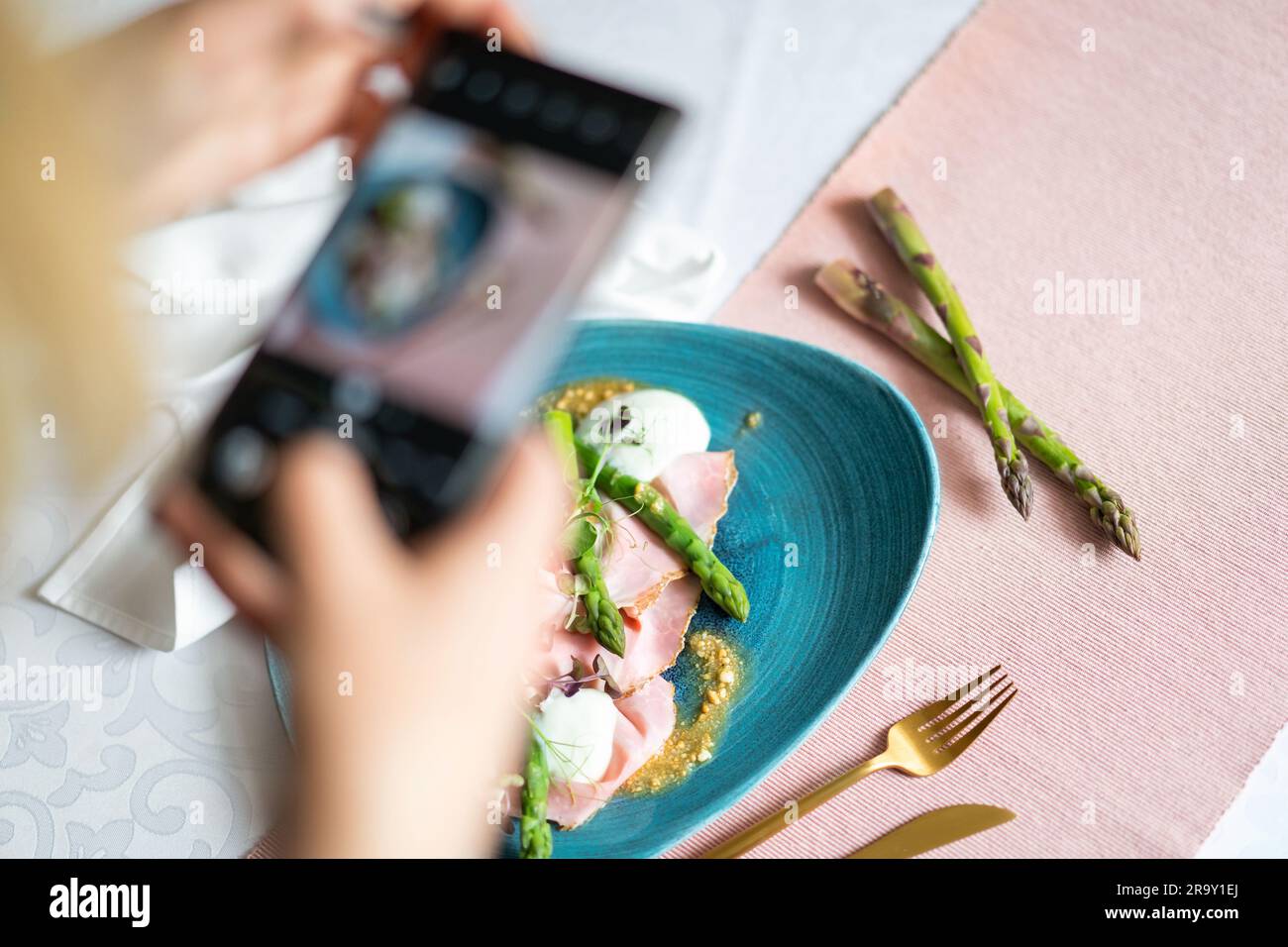 A woman taking a photo of the food with a smart mobile phone. Appetizer ...