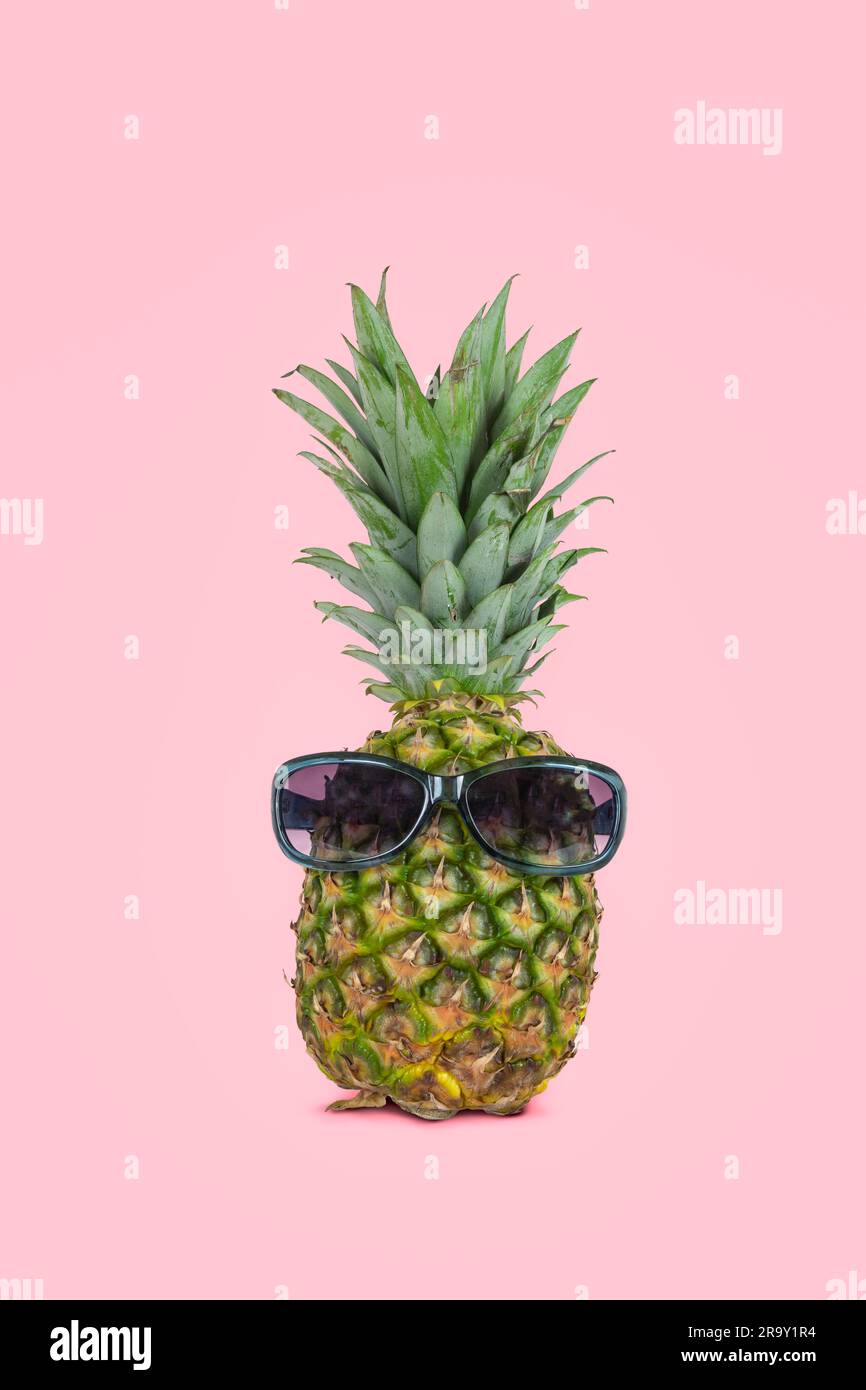 Pineapple wearing sunglasses on pink background. Minimal summer concept ...