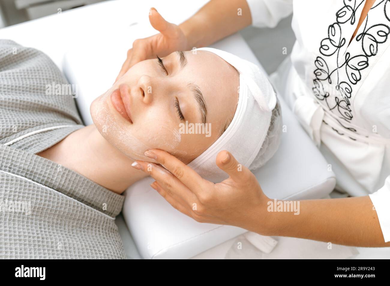 Facial skin care procedures in a beauty salon. The cosmetologist ...
