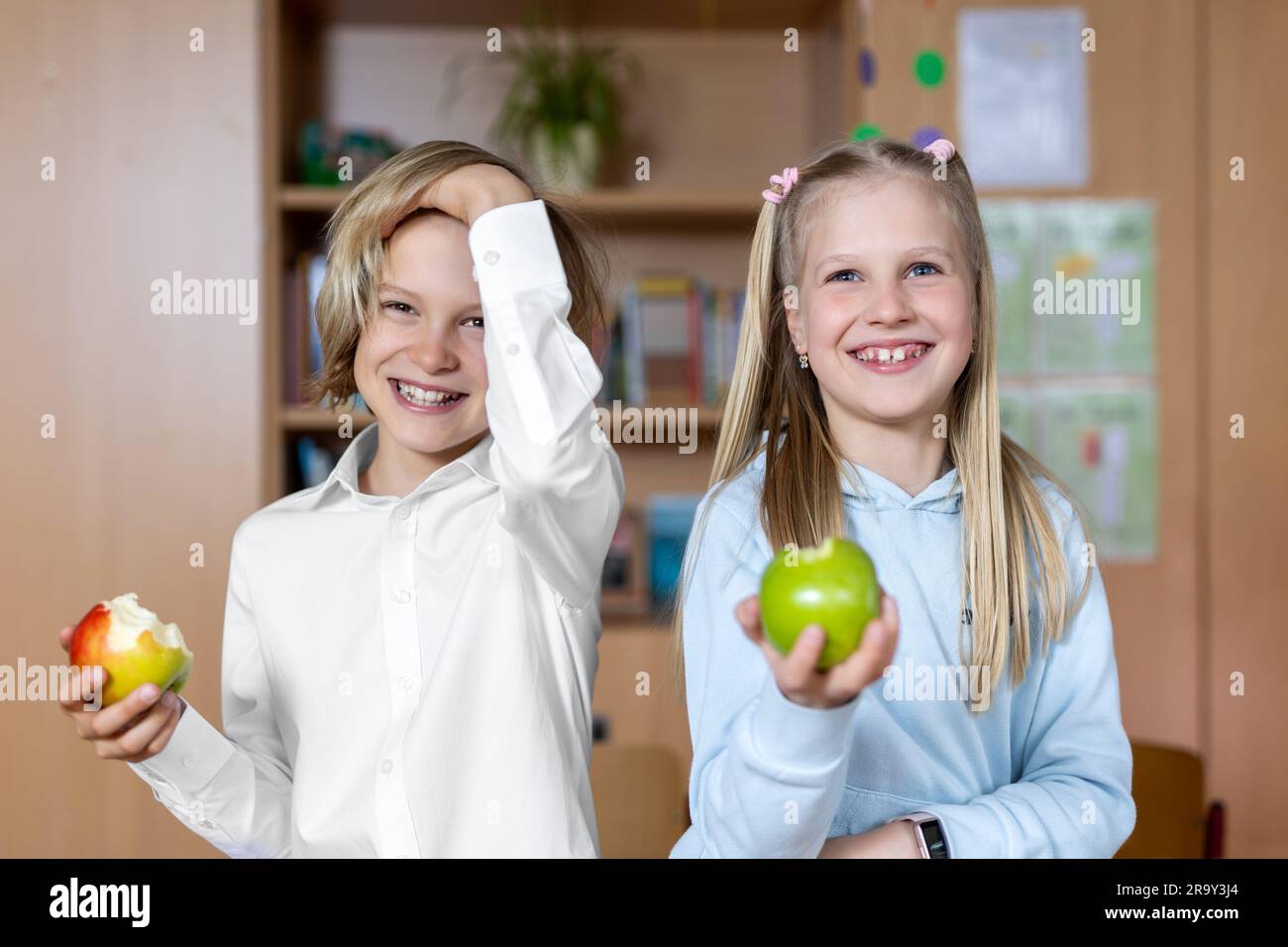 Portrait of two cute caucasian young blond little classmate friend kids ...