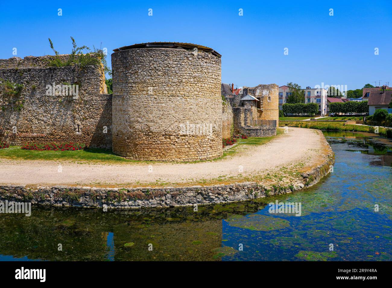 Water-filled moat below the round corner tower of the medieval castle ...