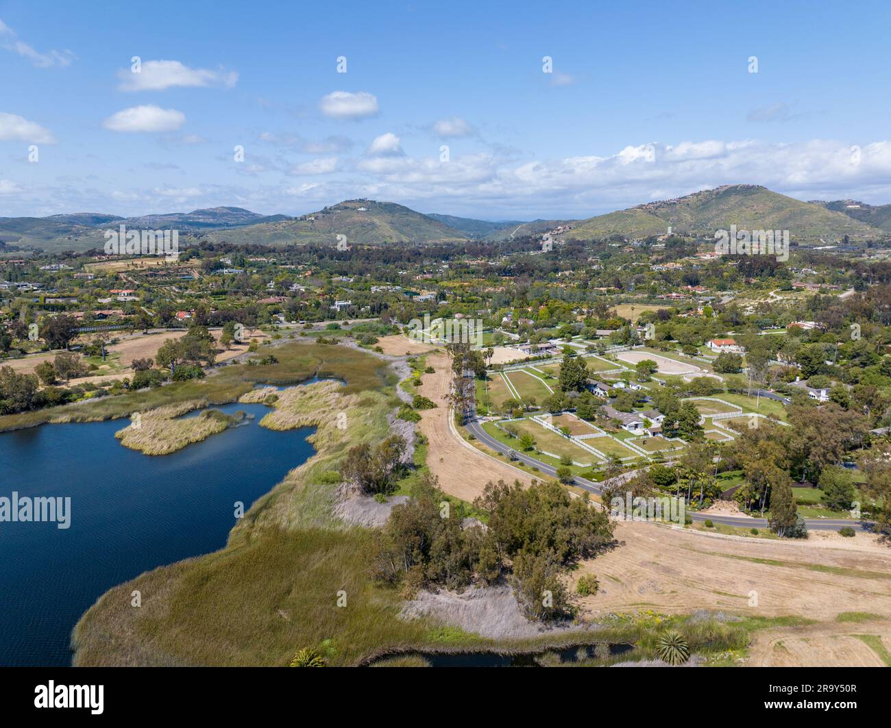 Aerial view over water reservoir and a large dam that holds water ...