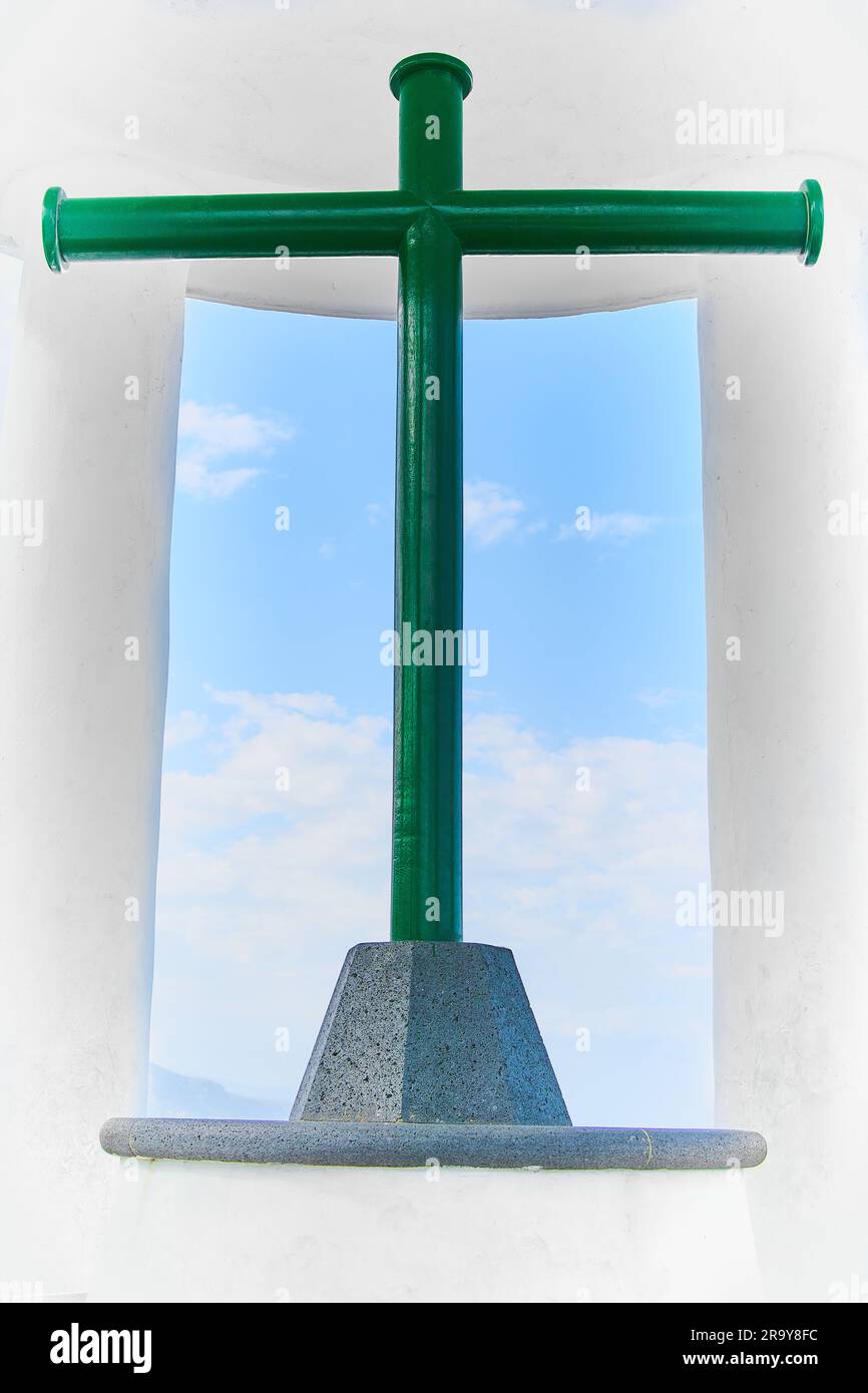 Christian cross in green with a stone base inside a dome and in the ...