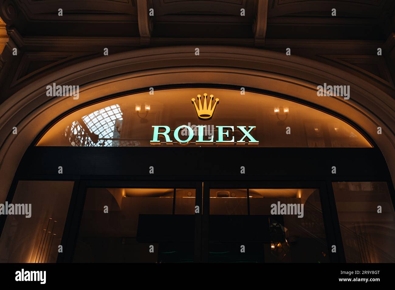 Facade of Rolex watch store in famous shopping mall GUM. Golden crown ...