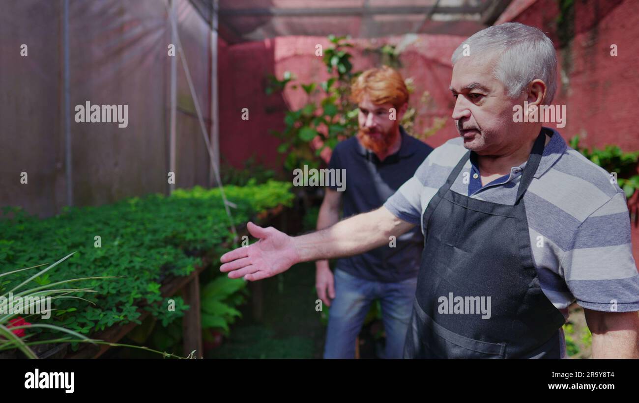 Experienced Gardener Assisting Customer at Plant Store. Horticulturist ...