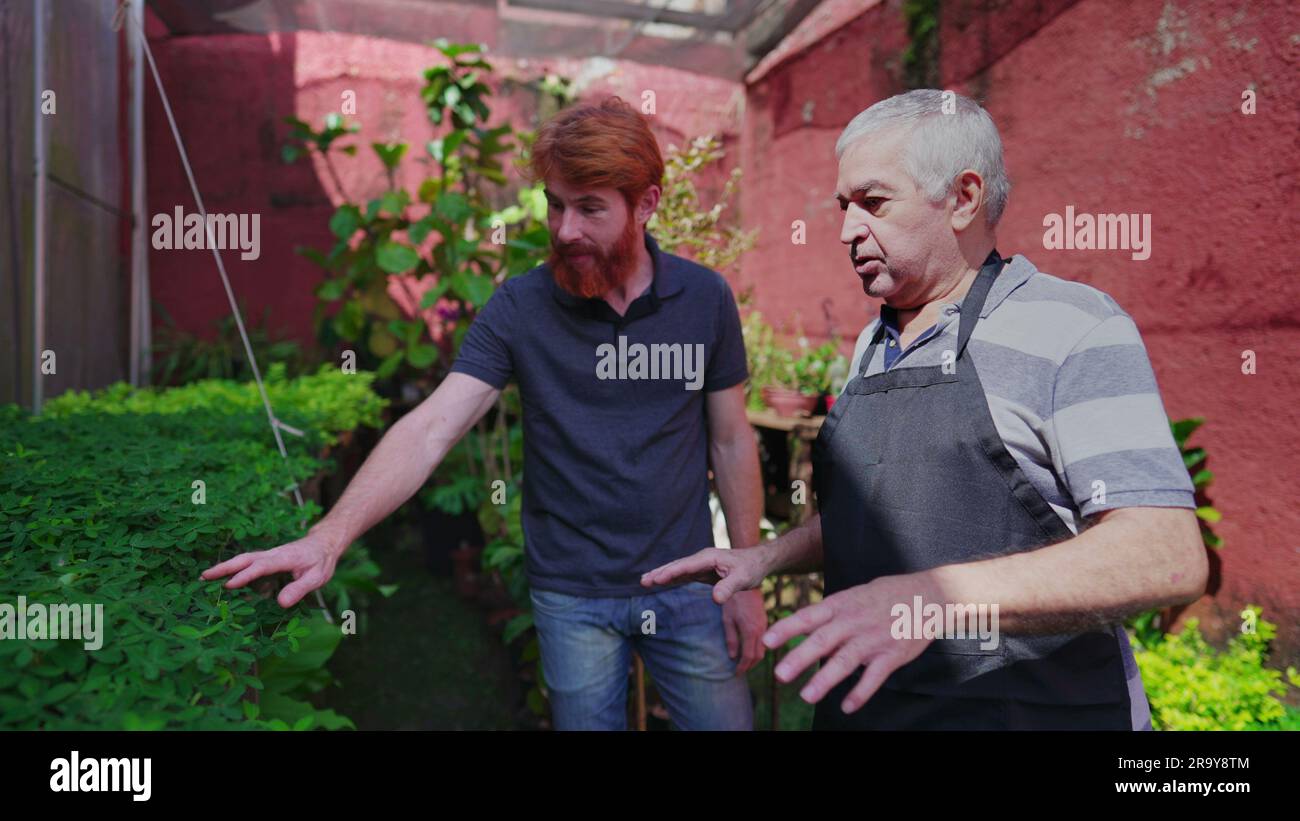 Experienced Gardener Assisting Customer at Plant Store. Horticulturist ...