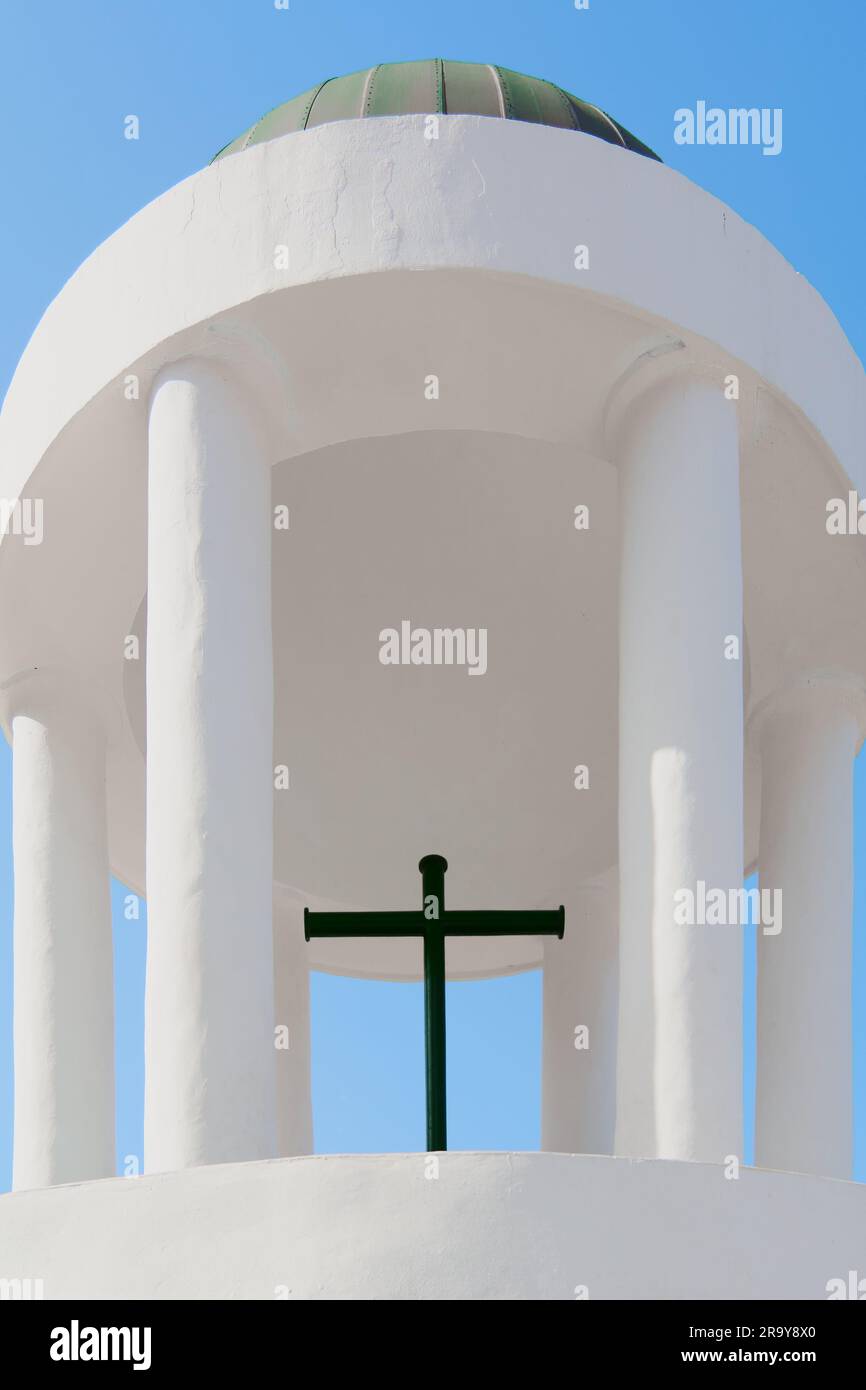 Christian cross in green with a stone base inside a dome and in the ...