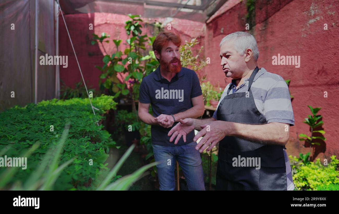 Experienced Gardener Assisting Customer at Plant Store. Horticulturist ...