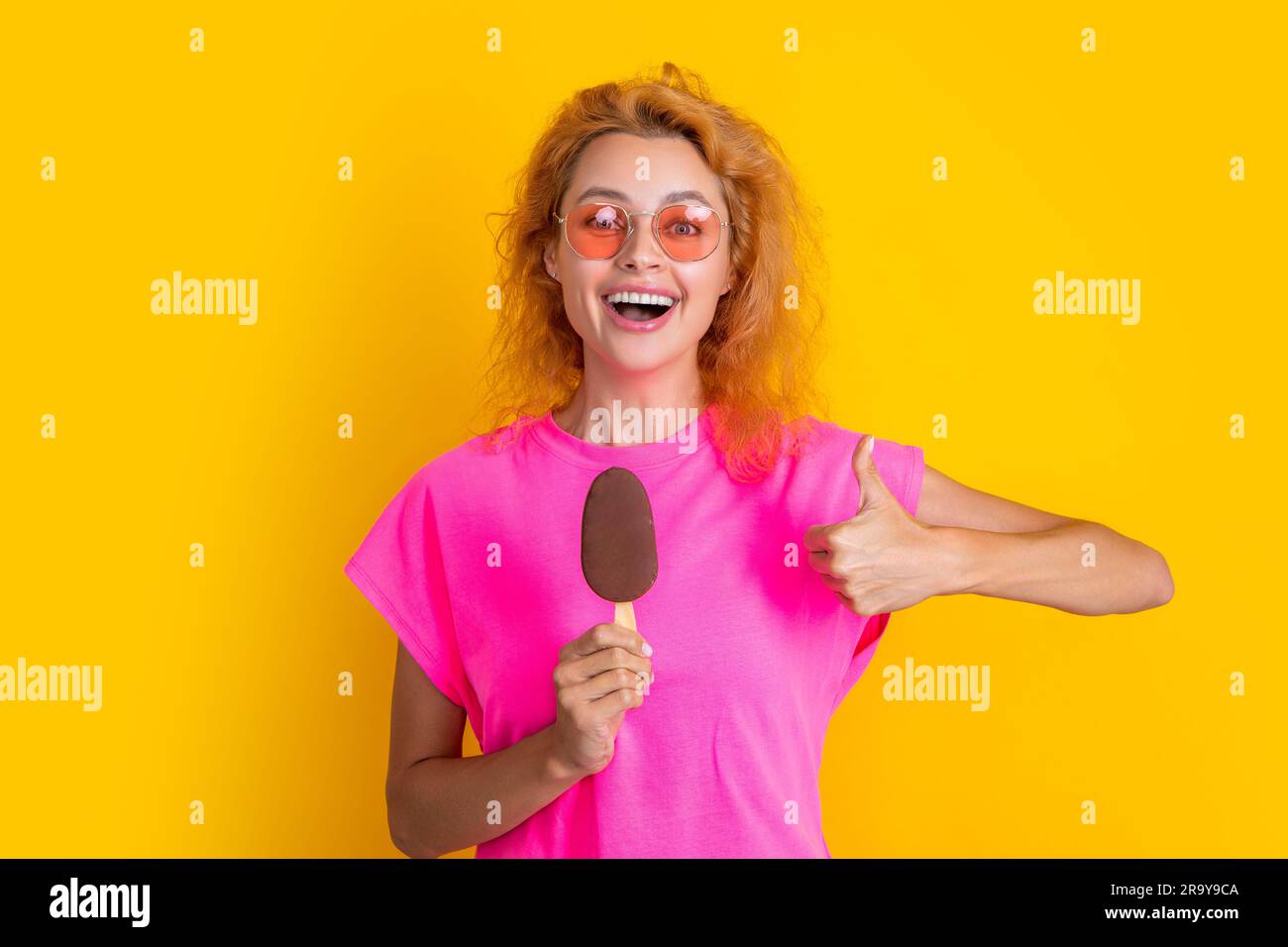 woman with icelolly ice cream in studio, thumb up. woman with icelolly ...
